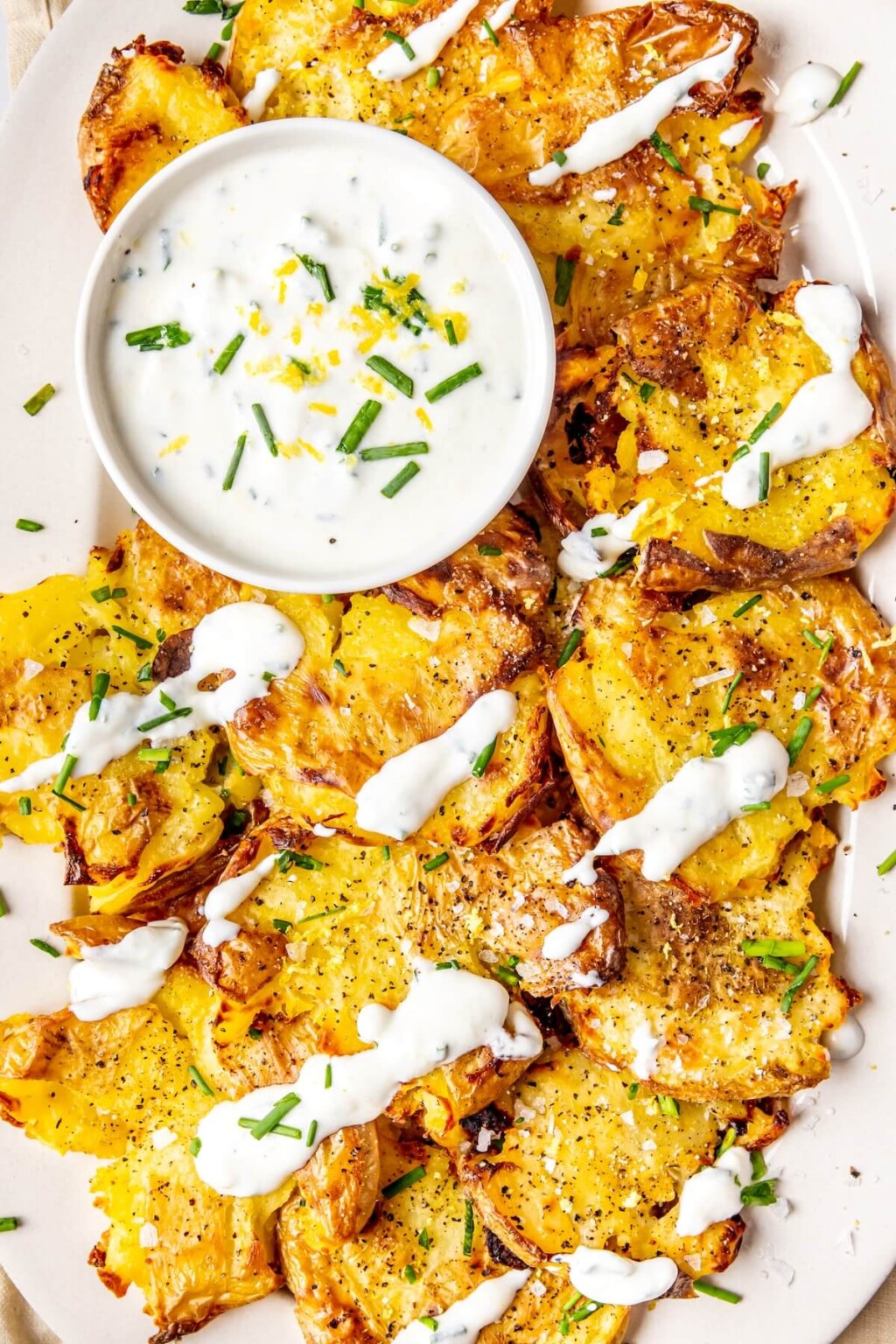 CRISPY SMASHED POTATOES WITH LEMONY CHIVE SAUCE